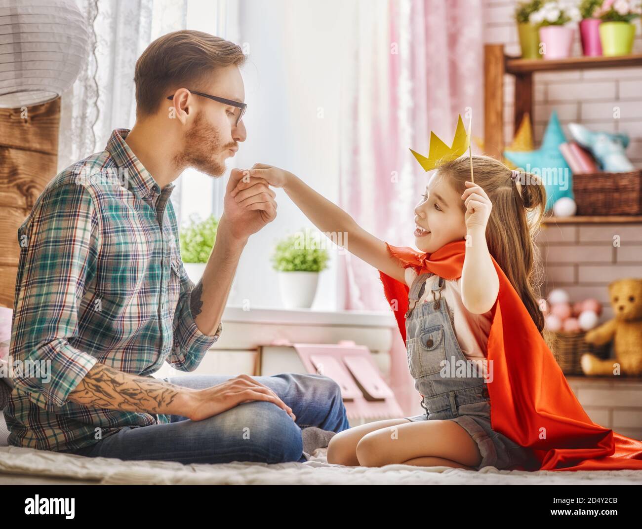 Funny time! Father and his child are playing at home. Cute girl holding ...