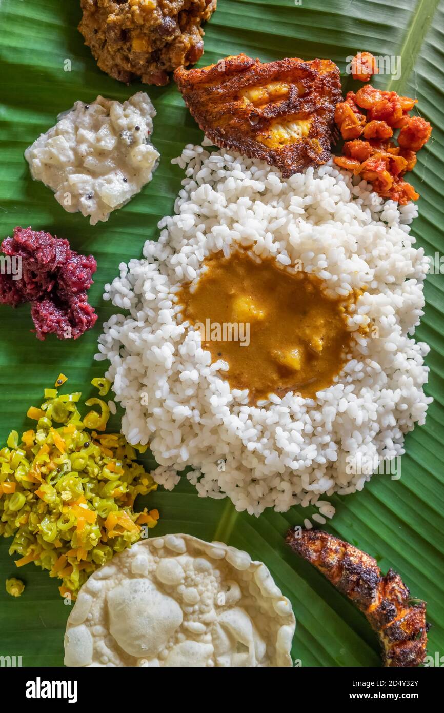 Homemade fish thali meal served at bannana leaf in Kerala state, India ...
