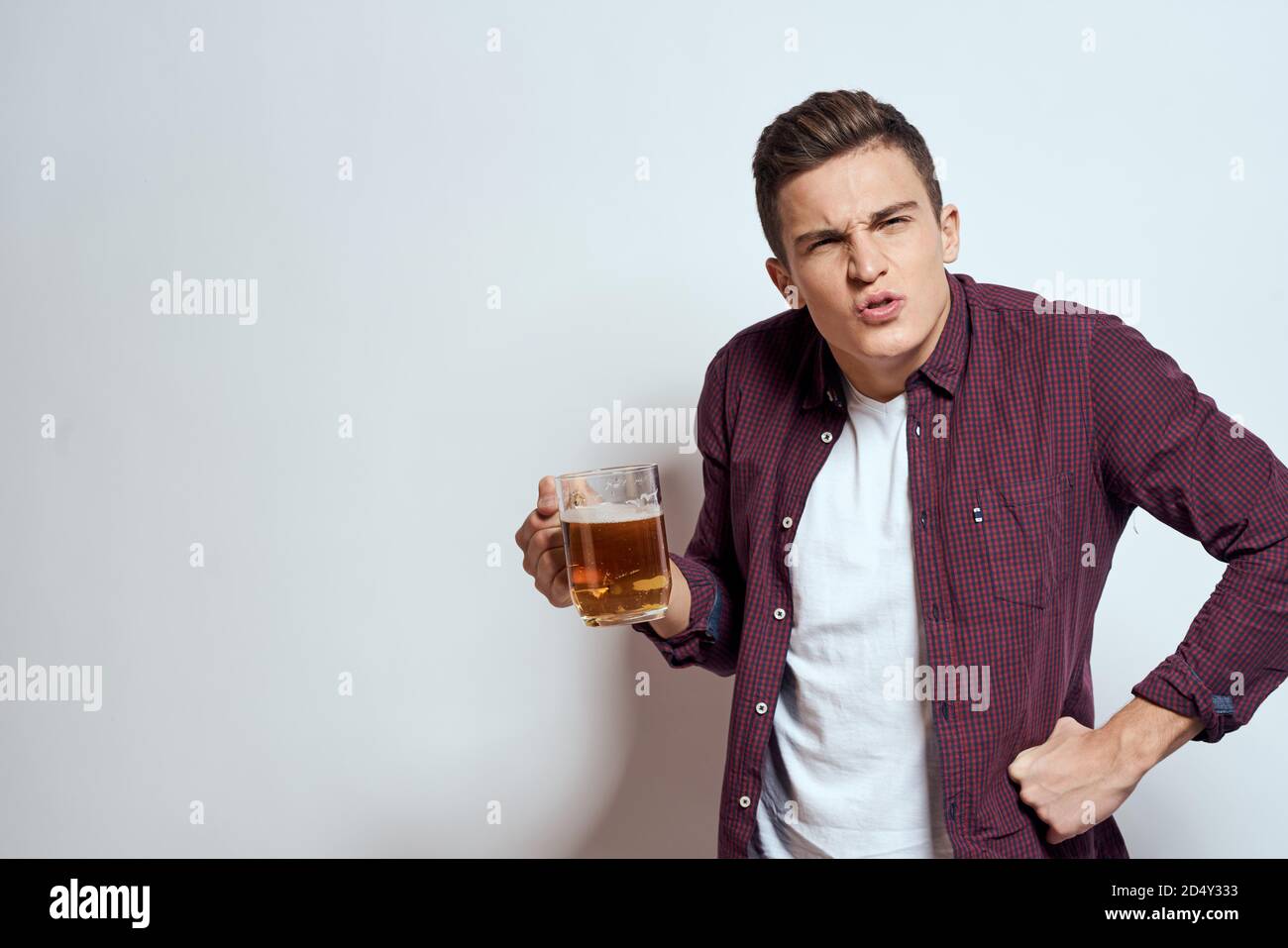 Drunk man with a mug of beer vacation alcohol lifestyle in a red shirt ...