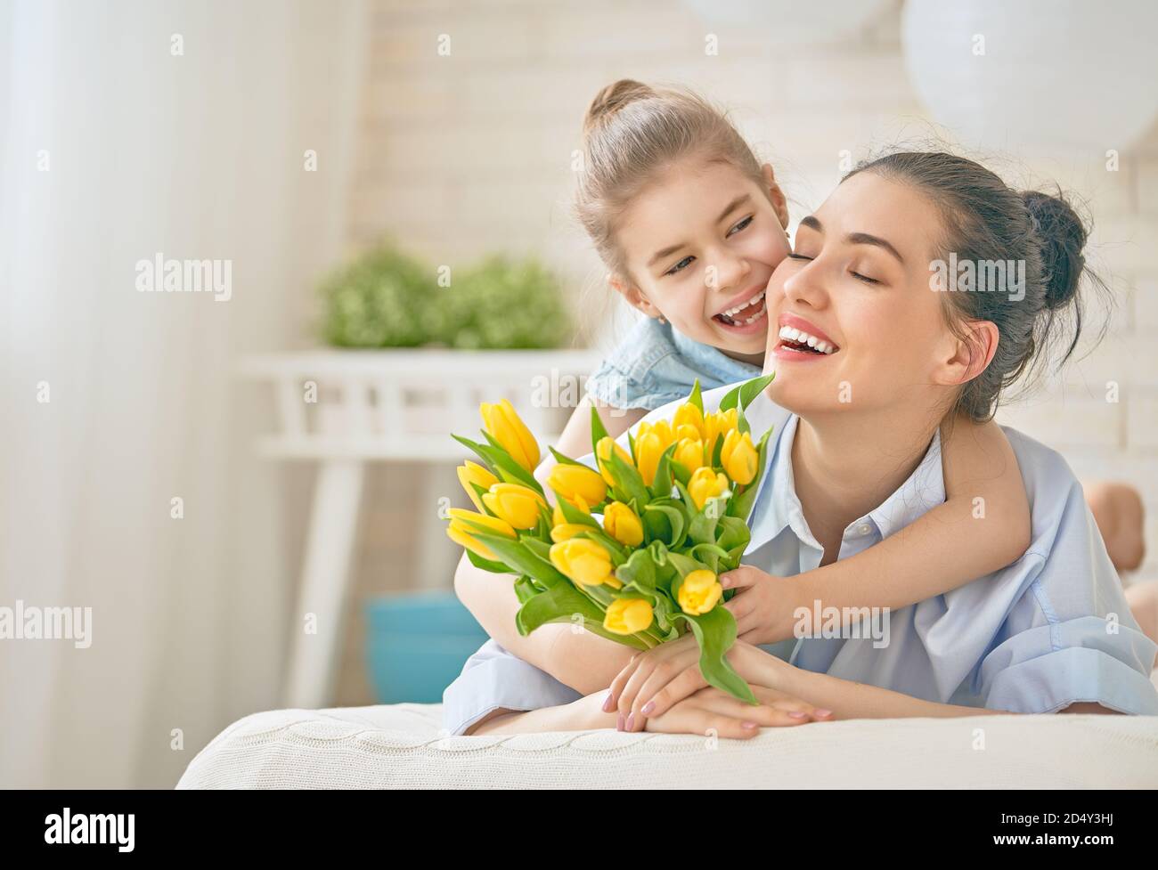 Happy mother's day! Child daughter is congratulating mom and giving her ...