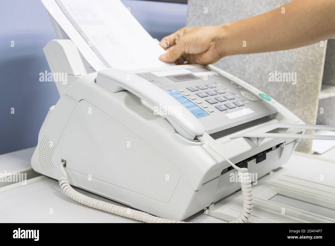 hand man are using a fax machine in the office, equipment for data ...