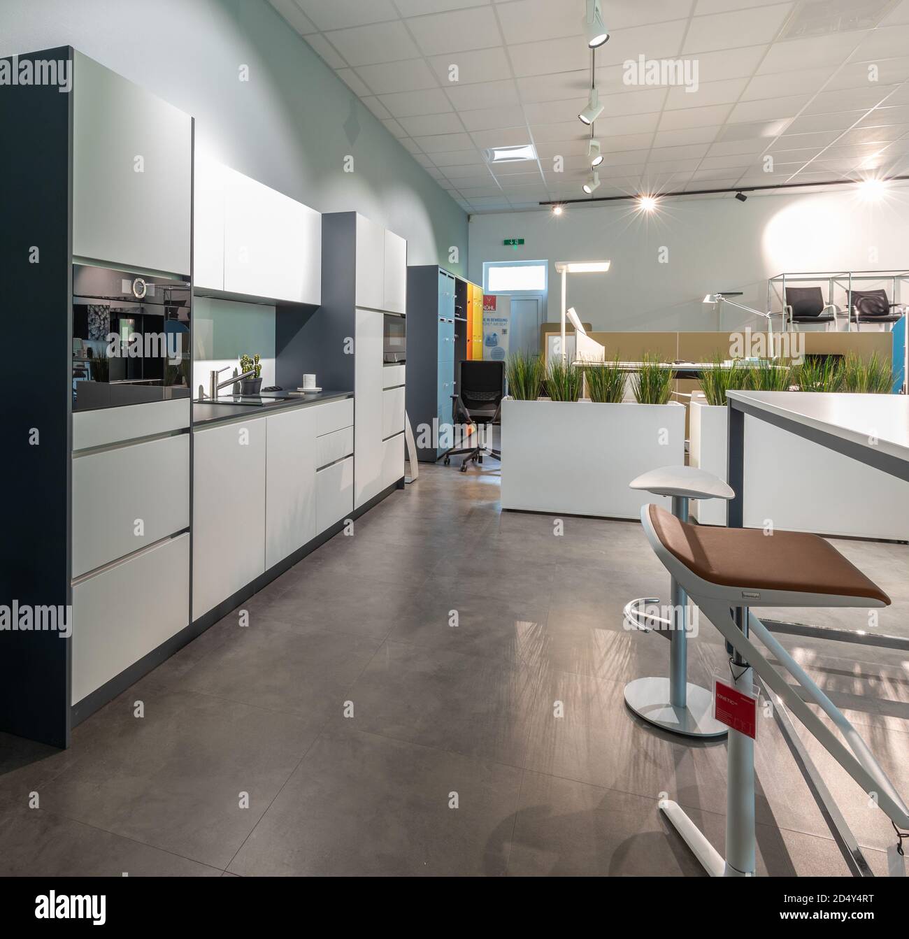 a white fitted kitchenette in an open-plan office Stock Photo - Alamy