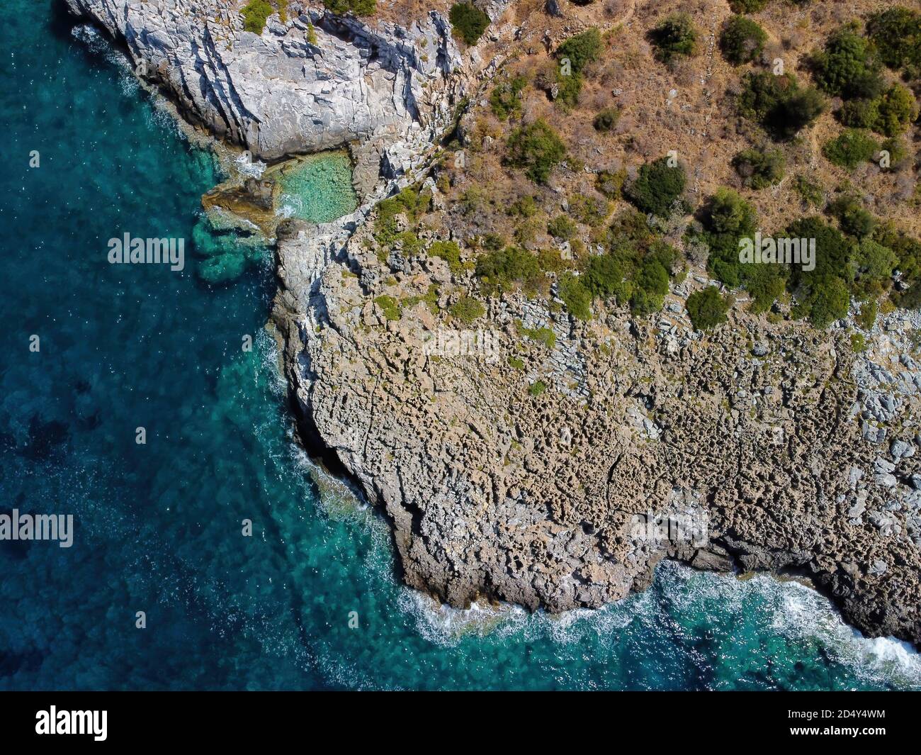 Aerial panoramic view of rocky beach and small pond near Trachila ...