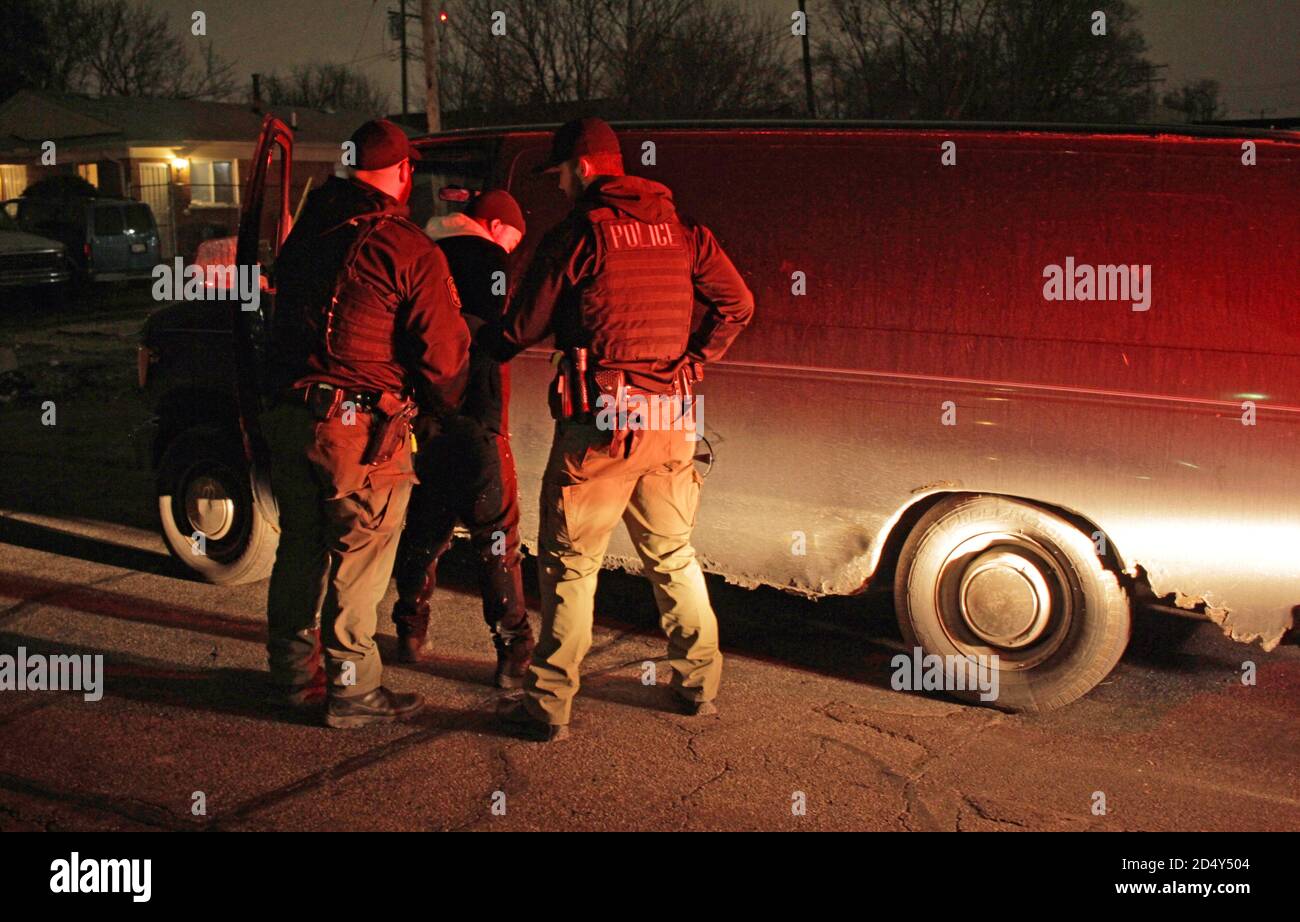 Detroit police officers detain and handcuff a man in Detroit, Michigan ...