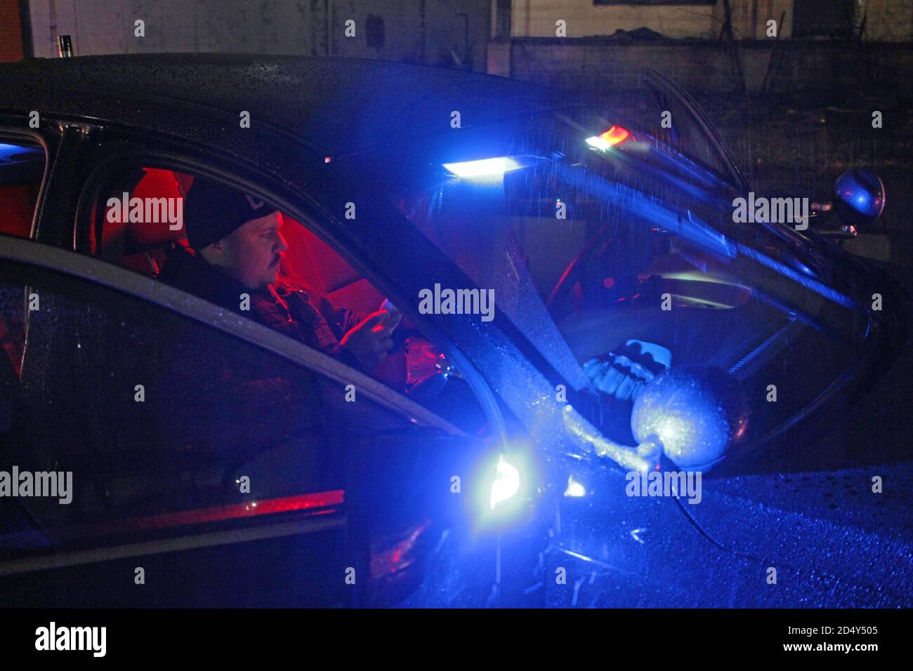 Detroit police officer checks a persons details on an onboard police ...