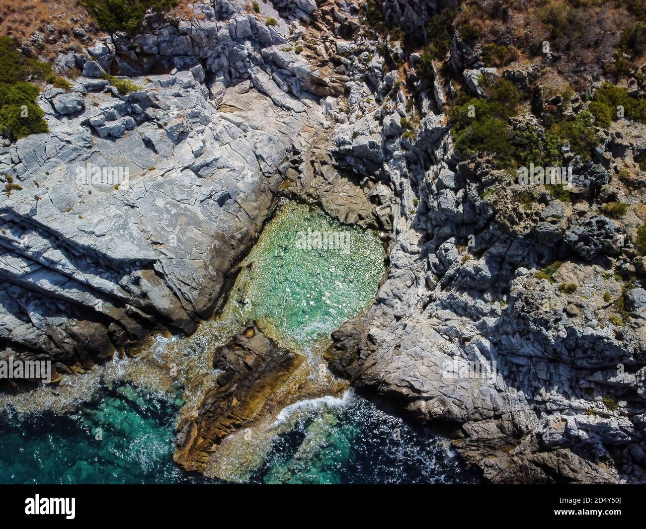 Aerial panoramic view of rocky beach and small pond near Trachila ...