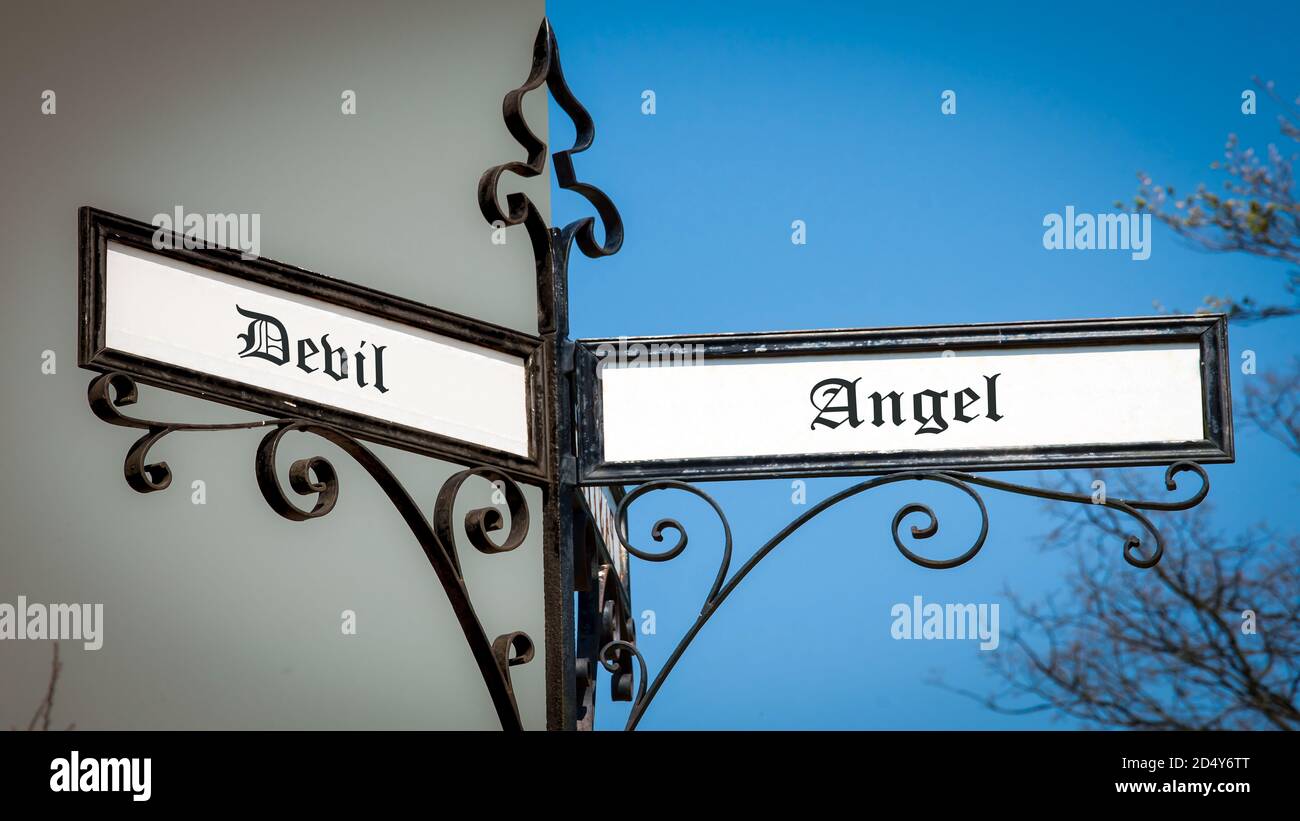 Street Sign the Direction Way to Angel versus Devil Stock Photo - Alamy