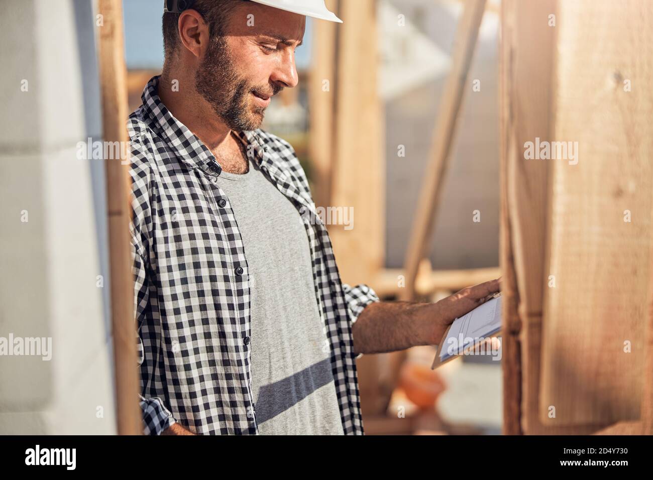 Qualified field engineer checking his plan at construction site Stock ...