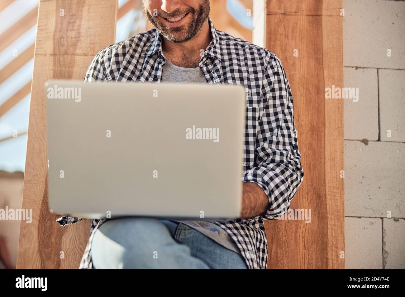 Hard-working brunette man using his laptop outside Stock Photo - Alamy