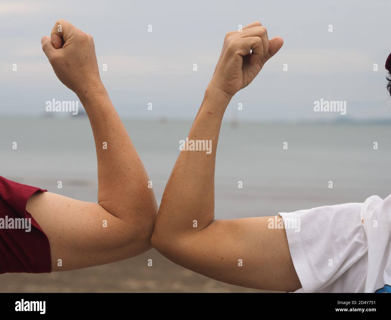 Two woman Alternative handshakes Elbow Bump greeting in the situation ...