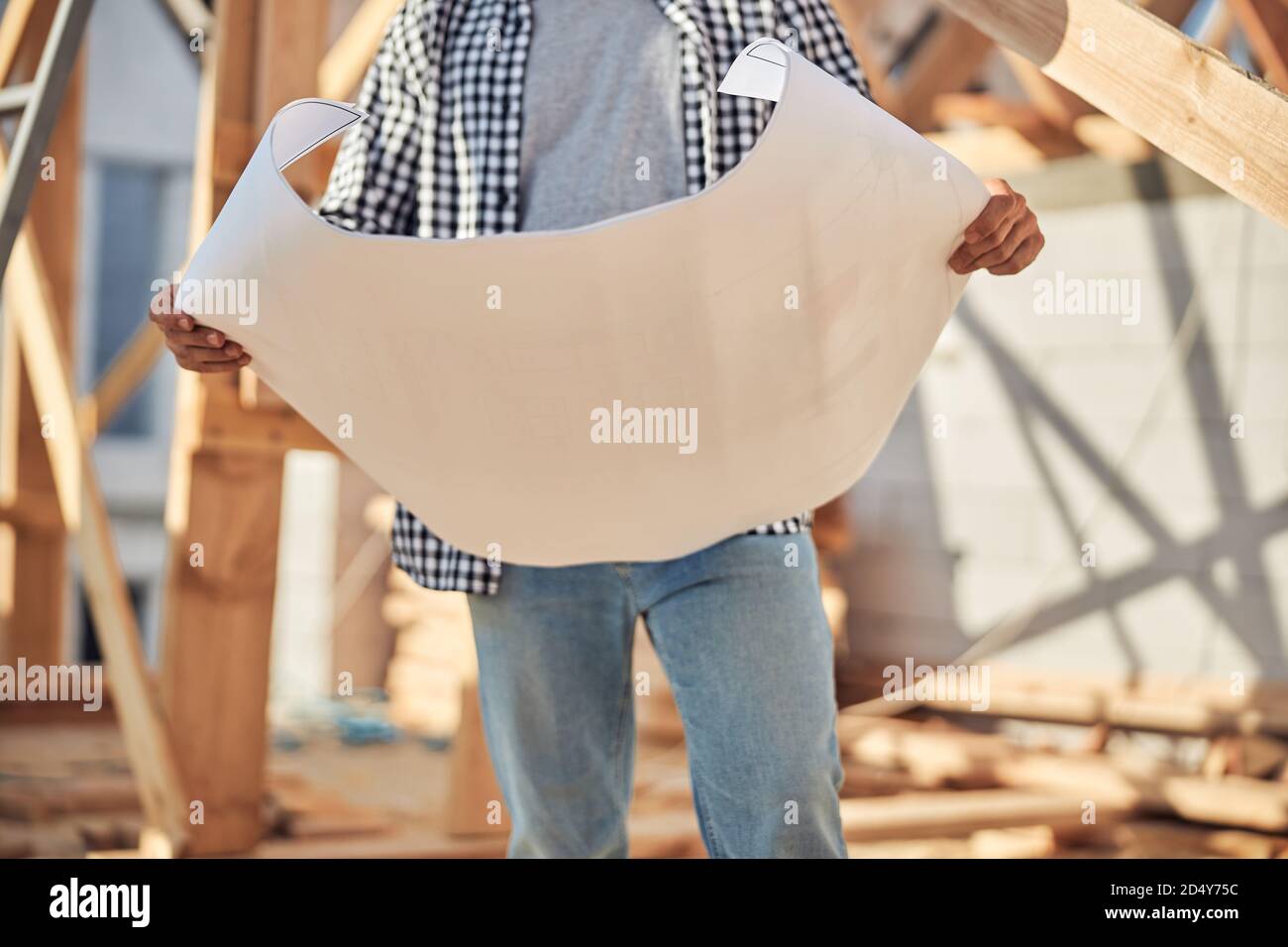 Professional engineer holding a paper with a building plan Stock Photo ...