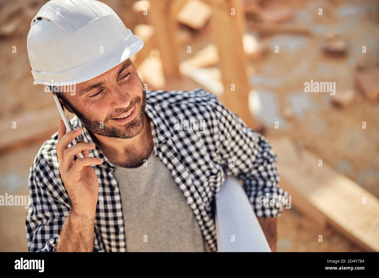 Professional architect making a phone call and holding paper roll Stock ...