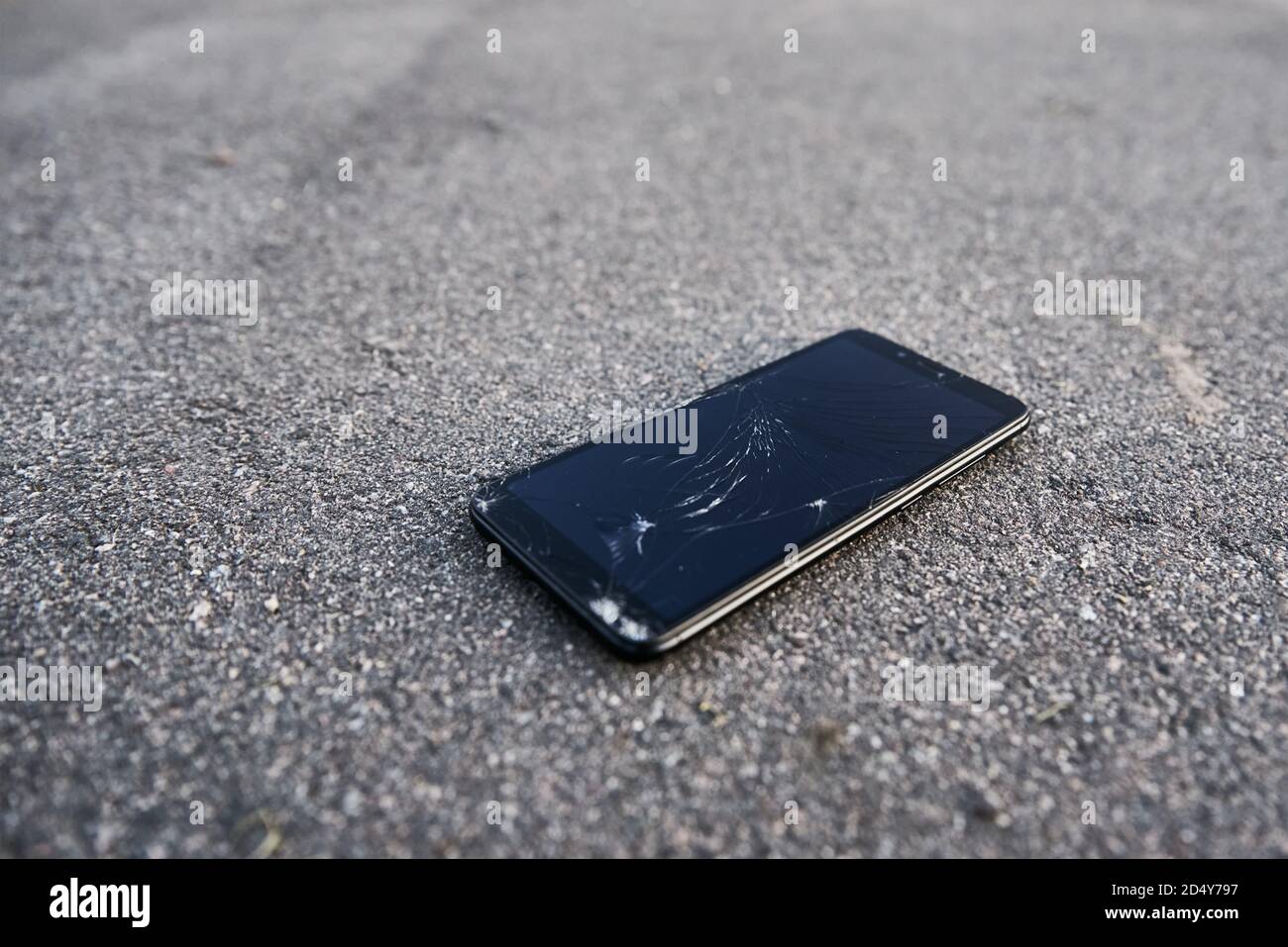 Damaged smartphone with broken touch screen on the asphalt Stock Photo ...