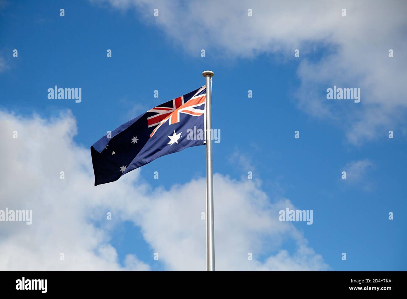 Australian flag flying with sky background Stock Photo - Alamy