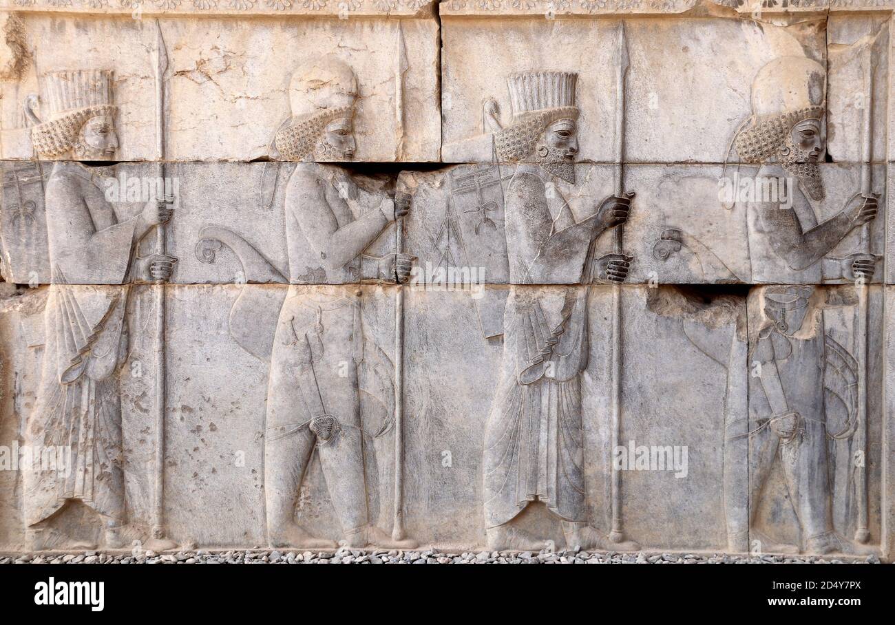 Ancient wall with bas-relief with assyrian warriors with spears ...
