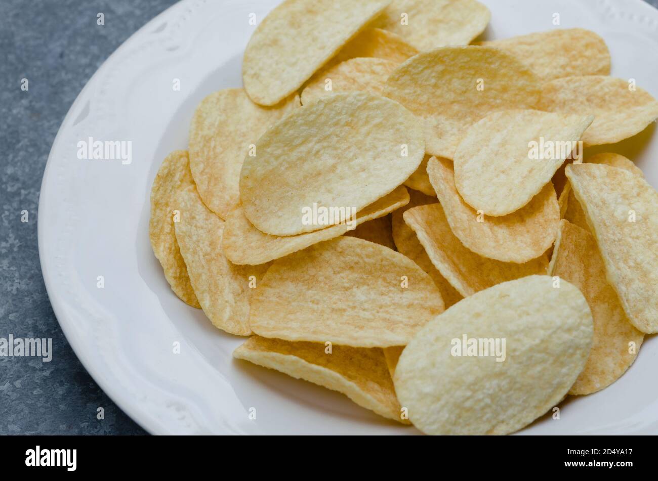 Fried Potato Chips in White Ceramic Plate Stock Photo - Alamy