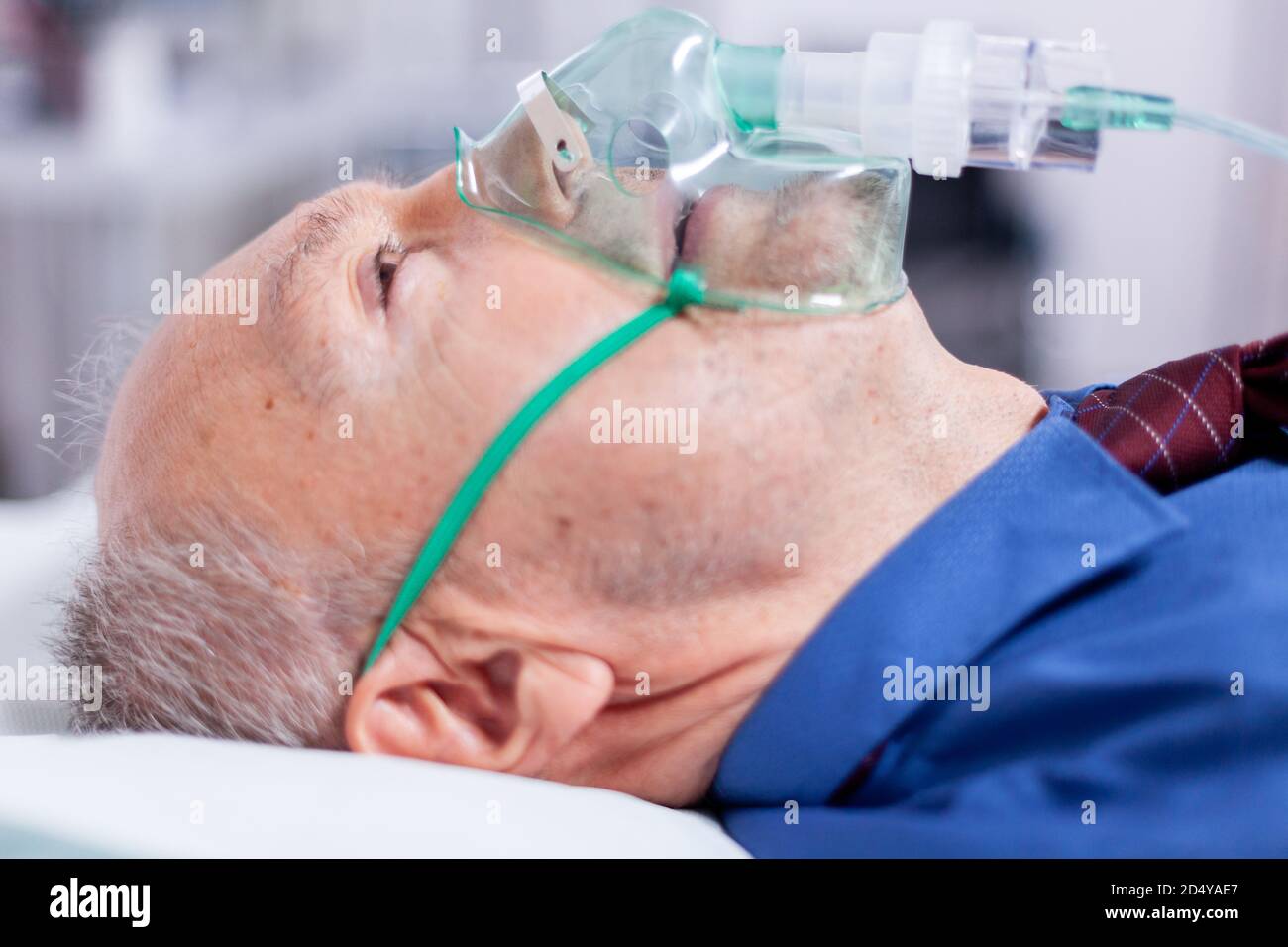 Old man breathing with oxygen mask in hospital bed during coronavirus ...