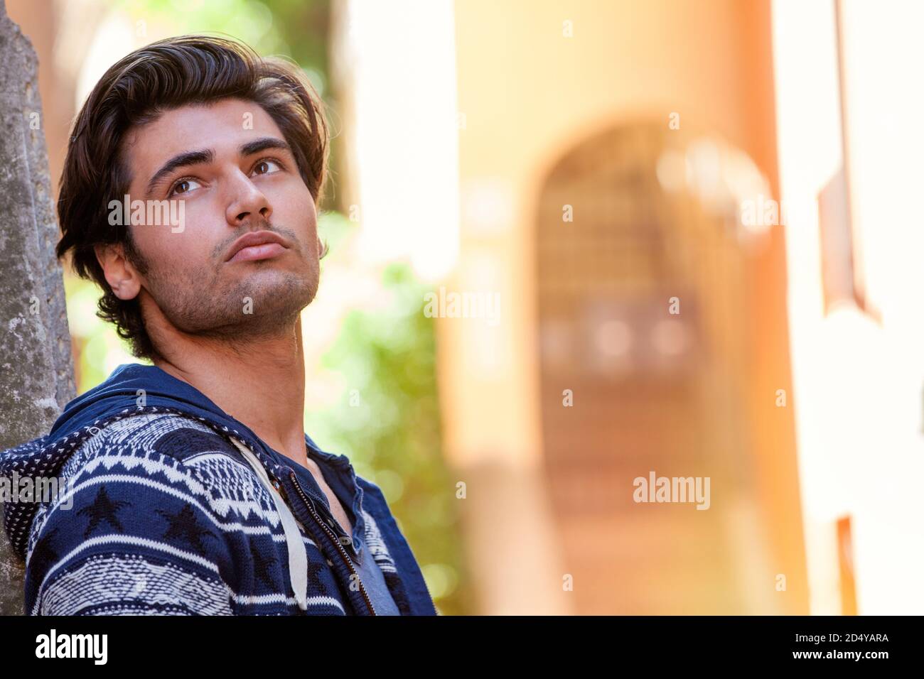 Young dreamer man thinking. A beautiful young man is looking up ...