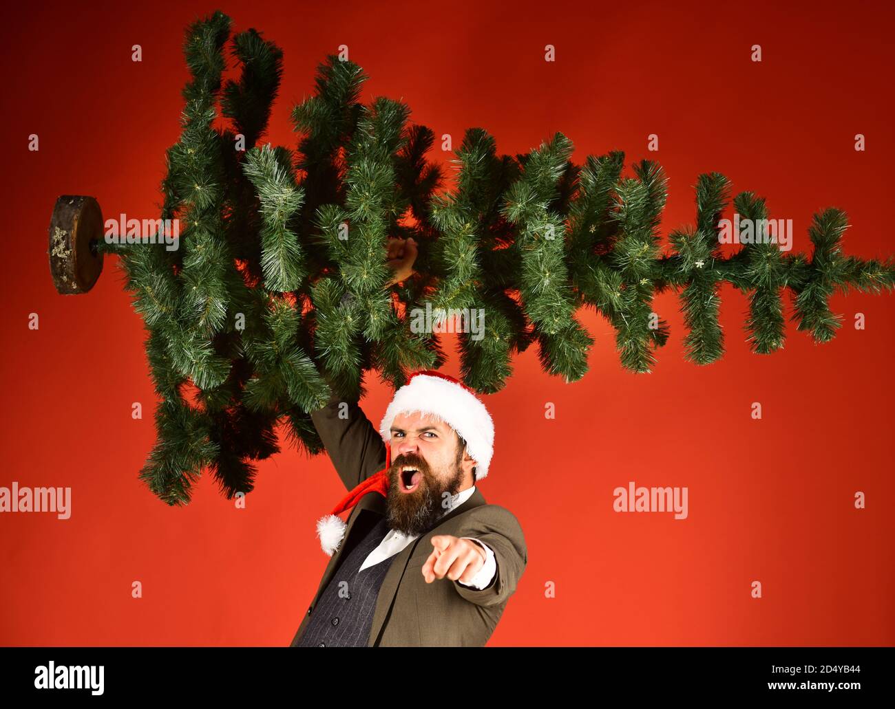 Christmas corporate party concept. Man in suit and Santa hat on red ...