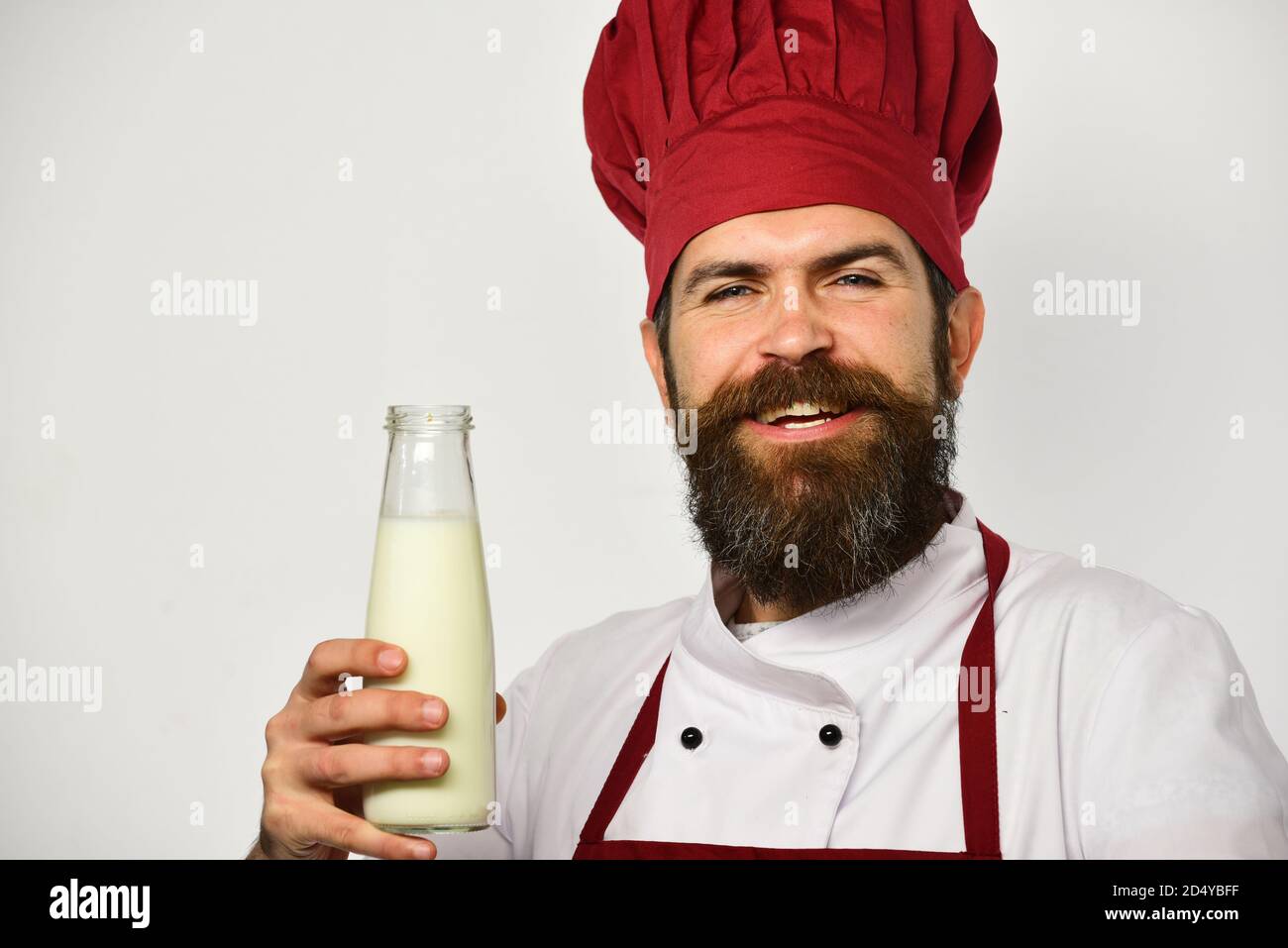 Organic ingredients concept. Cook with smiling face in burgundy uniform ...