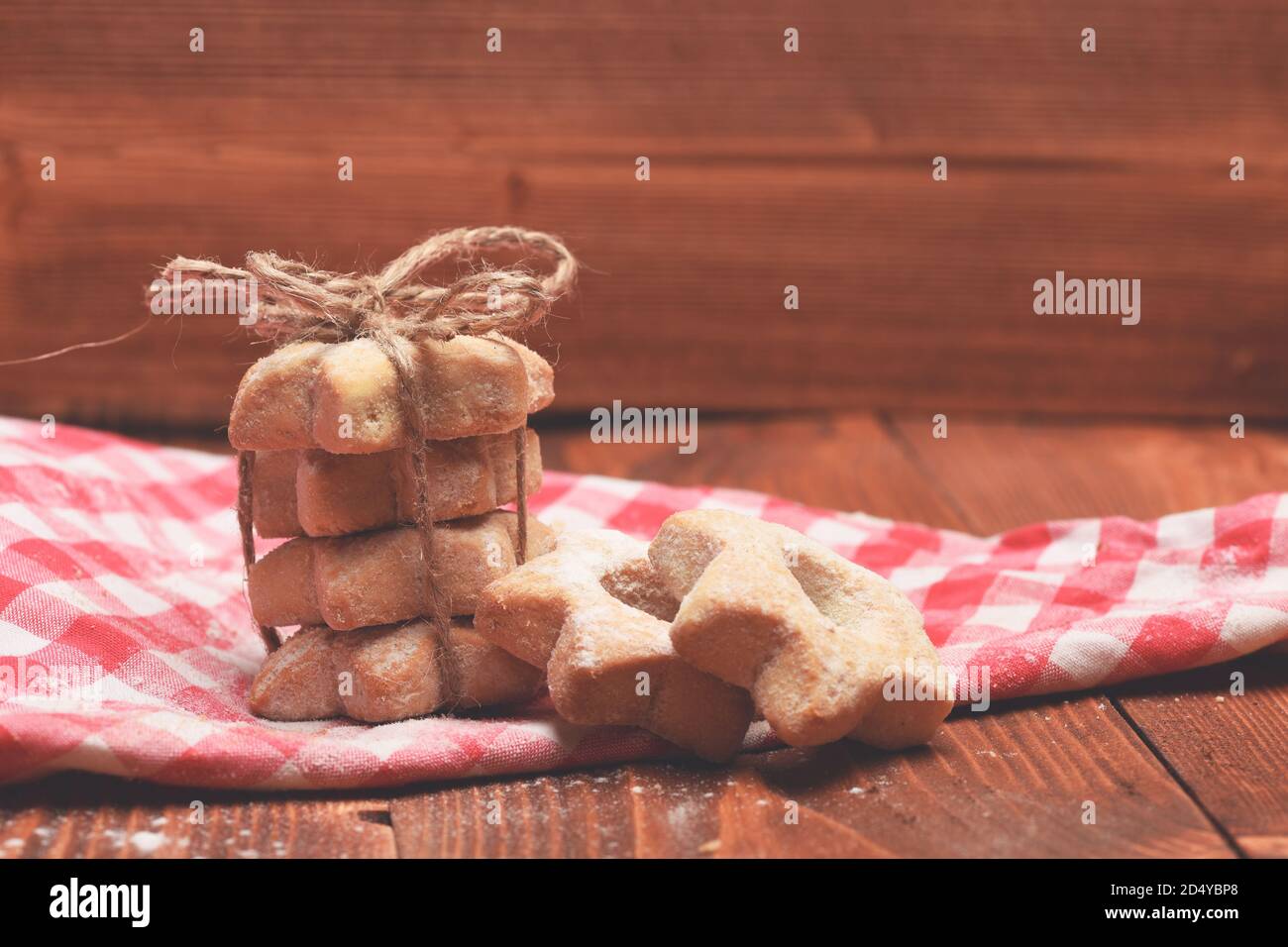 Star shaped biscuits tied in pyramid on red cloth. Homemade pastry ...