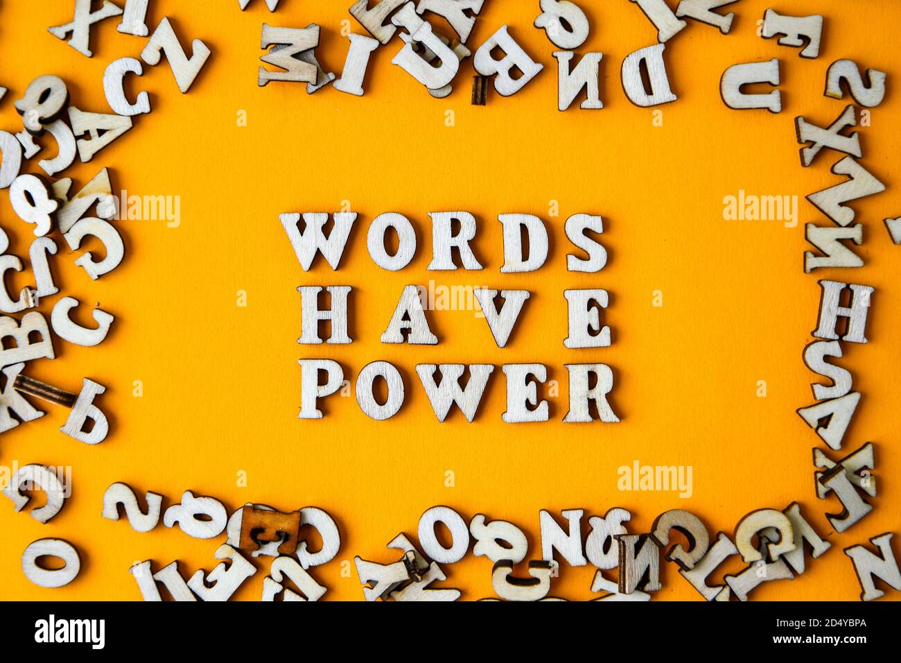 Quote WORDS HAVE POWER made out of wooden letters on bright yellow ...
