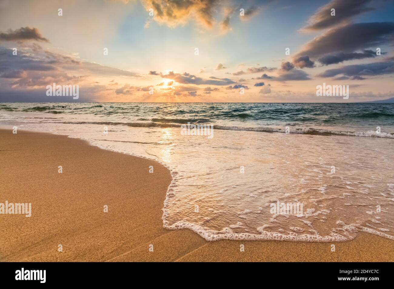 A Sunset Ocean Wave is Breaking on the Sea Shore with the Sun Setting ...