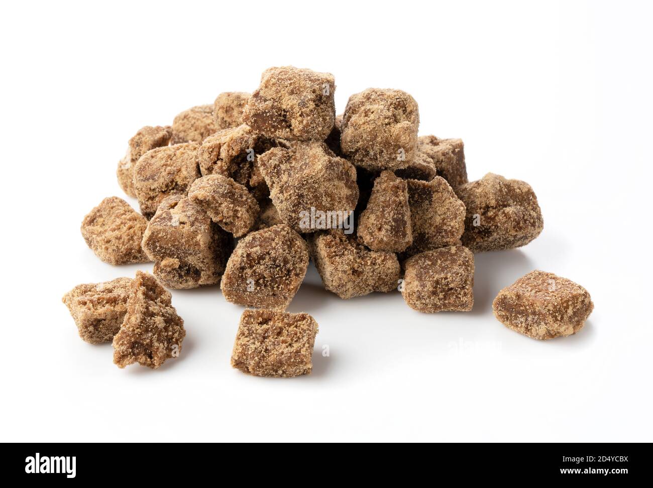 Shooting a block of brown sugar placed on a white background from an ...