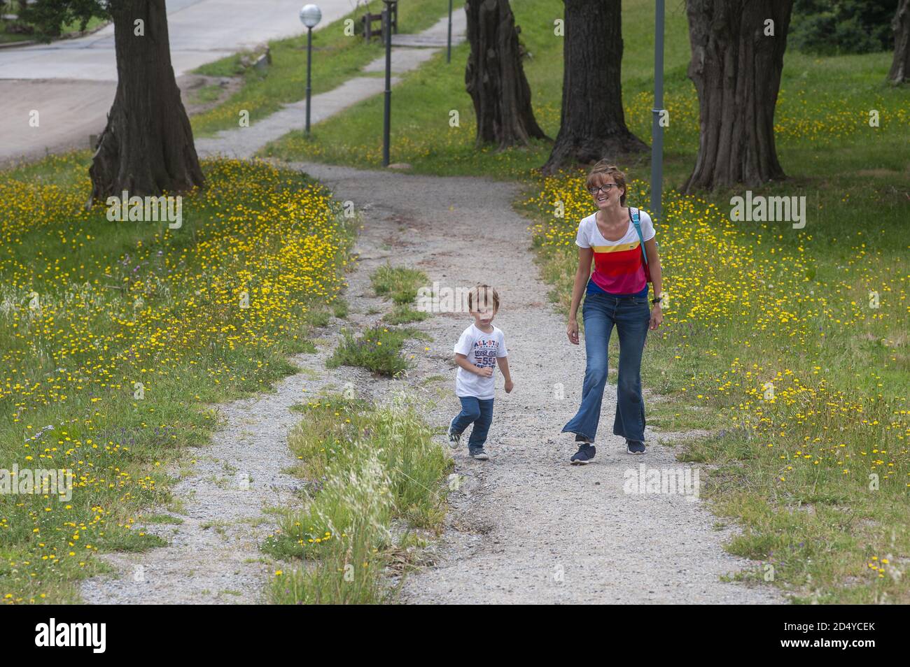 Young mother walking home with her son after school Stock Photo - Alamy