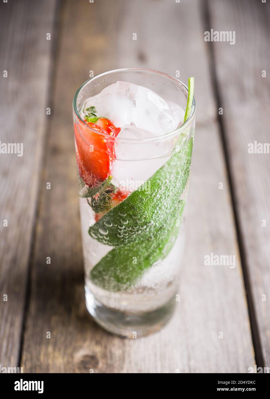Fresh cocktail with ripe strawberry and sage leaves. Selective focus ...