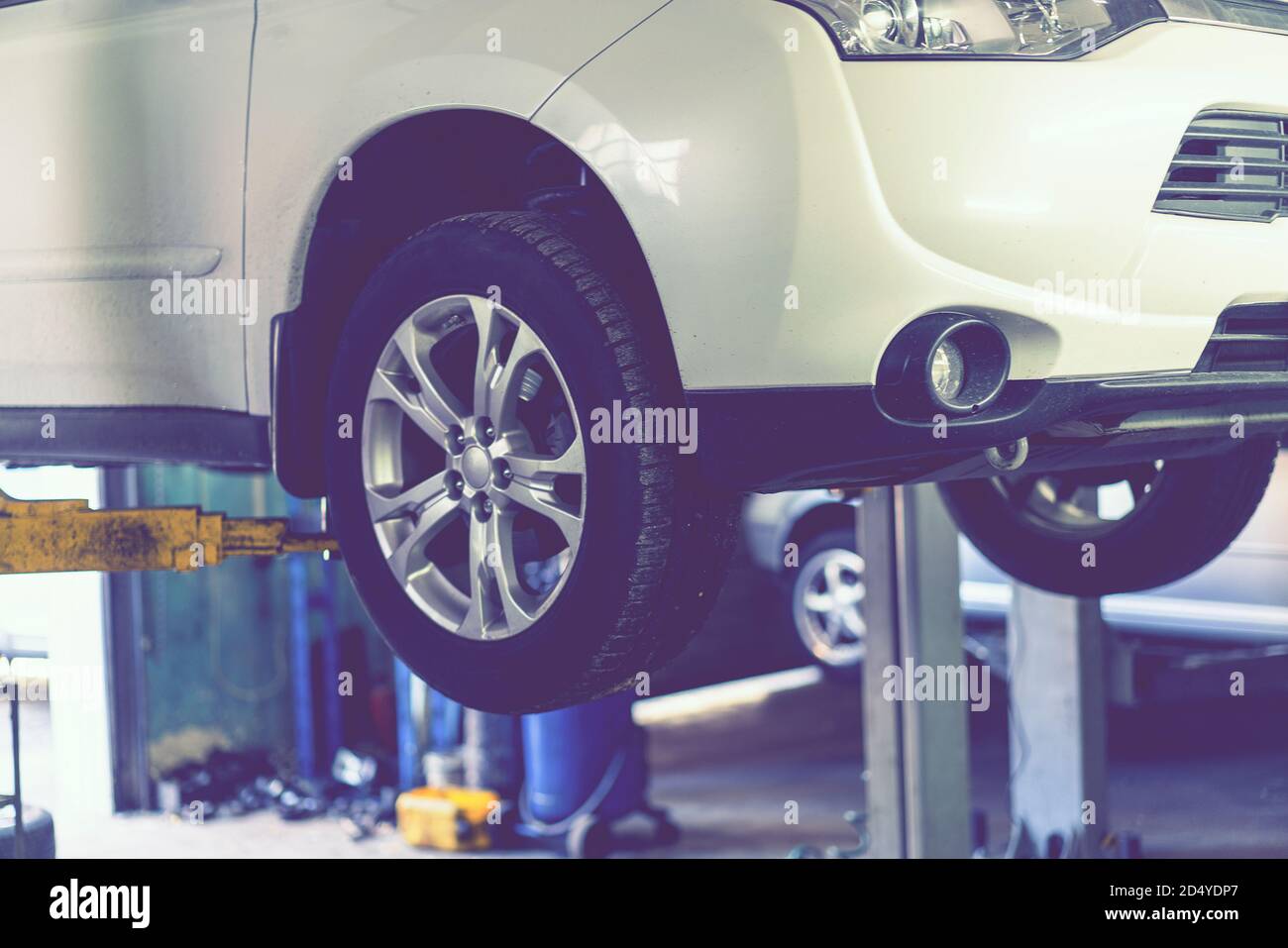 Car on a lift in a car repair station. Lifted chassis car for repairing ...