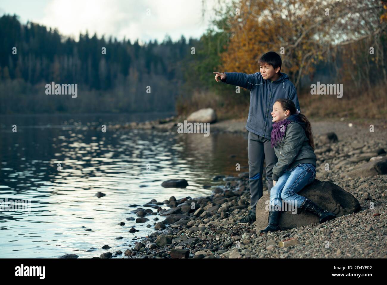 Couple of teenagers romantically a date near the river. Nord of Russia ...