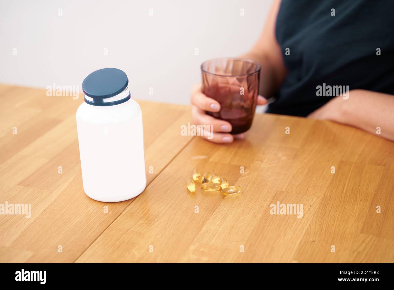 Caucasian woman takes supplements in the morning. Vitamins, pills, self ...