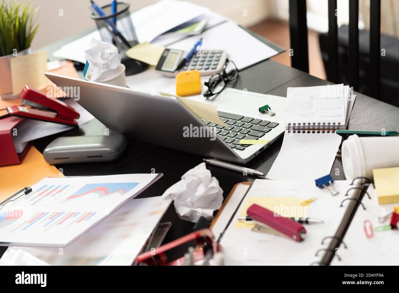 Messy and cluttered office desk Stock Photo - Alamy
