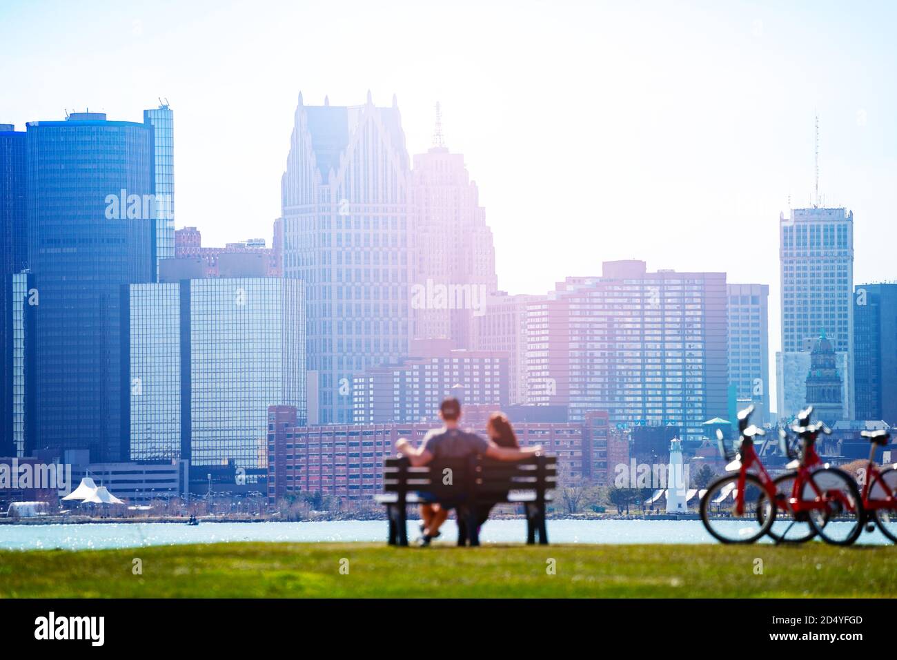 Lovely couple sit in the bench on Sunset Point over Detroit river and ...