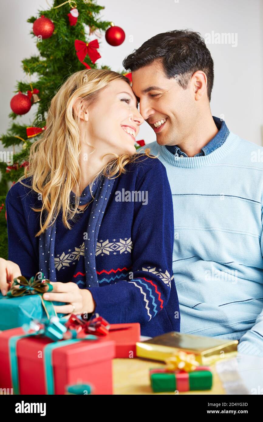 Couple in love with lots of presents at Christmas Stock Photo - Alamy