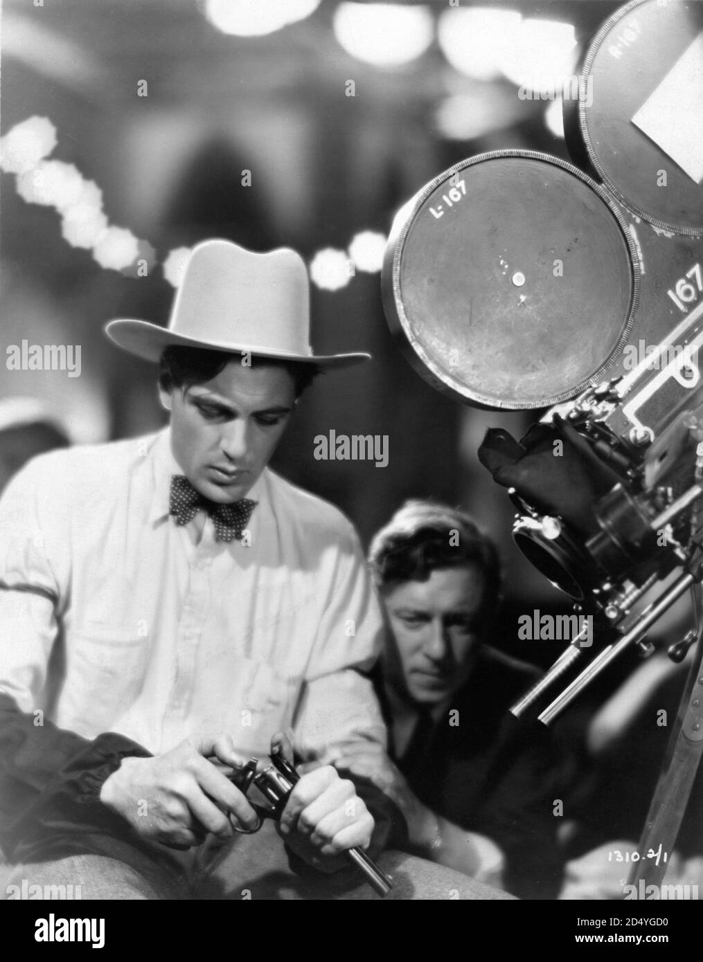 GARY COOPER on set candid filming close up of loading gun for CITY ...
