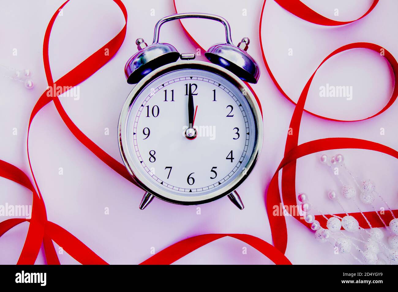 Bright festive red ribbon, curl and a beautiful vintage silver alarm ...