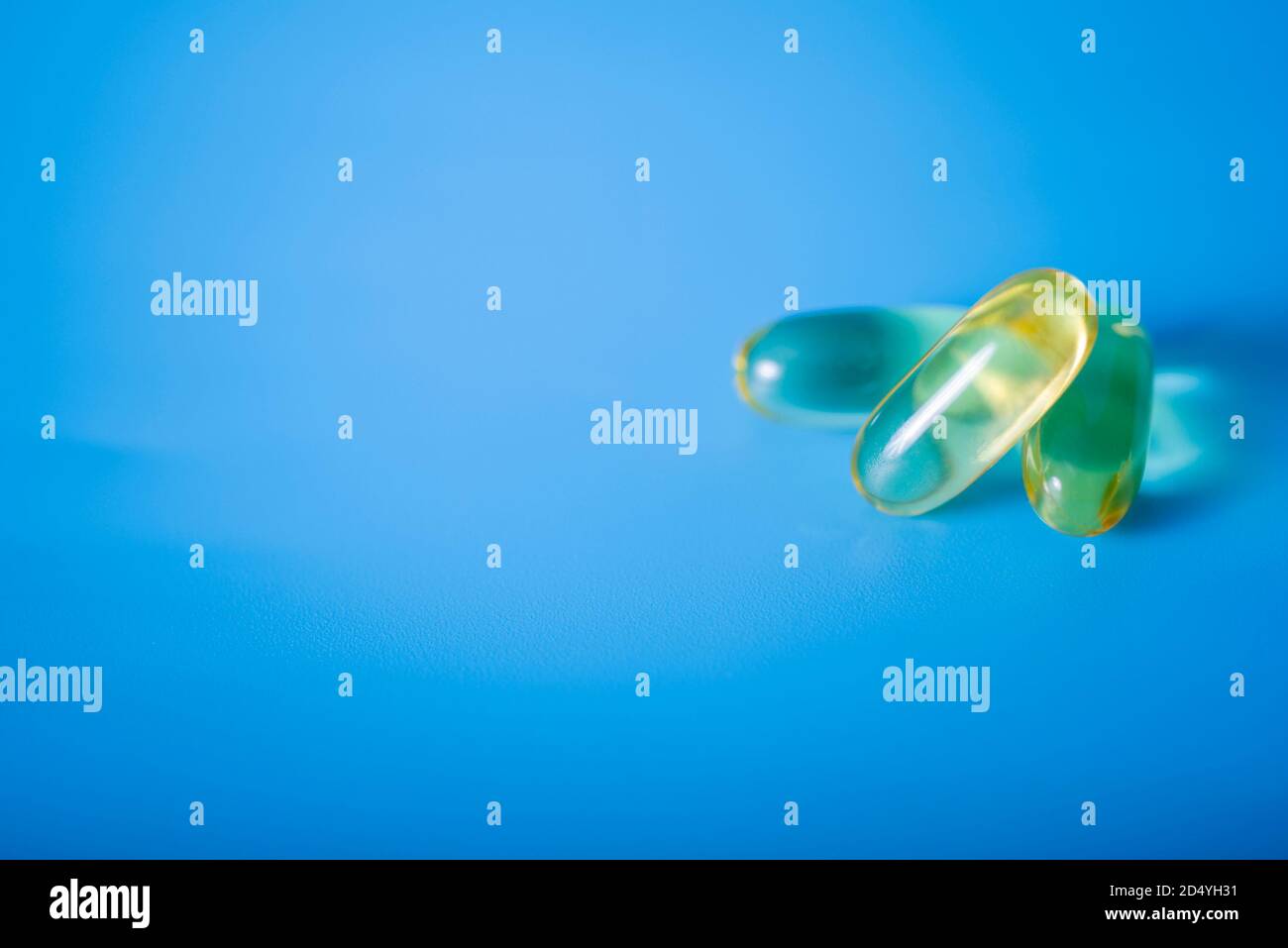 Omega 3 health capsules on a blue background. The concept of a healthy ...