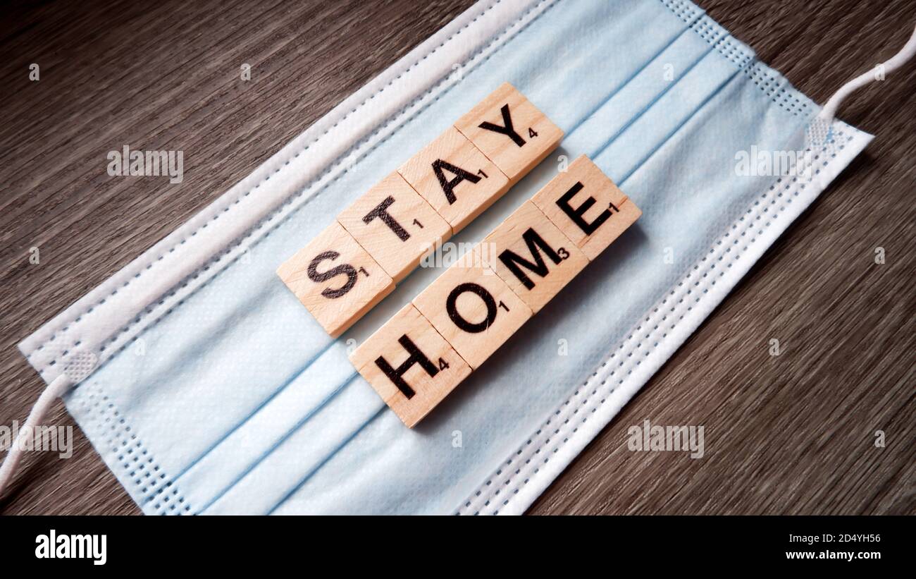 STAY HOME word text on face mask background Stock Photo - Alamy