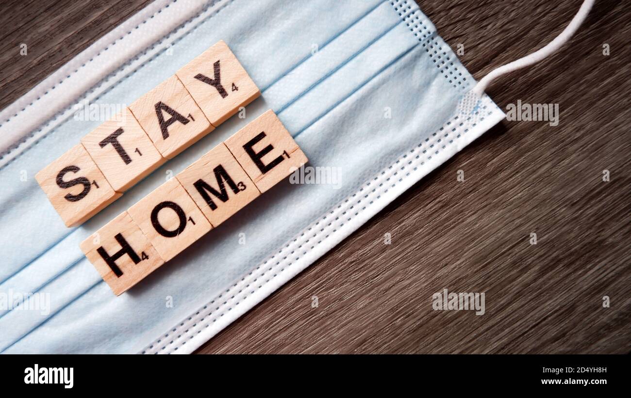STAY HOME word text on face mask background Stock Photo - Alamy