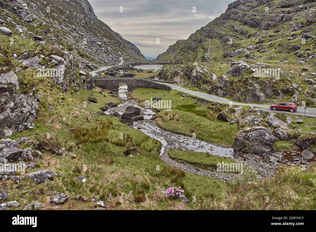 Small road winding through the gap of dunloe, Ireland. Panoramic view ...
