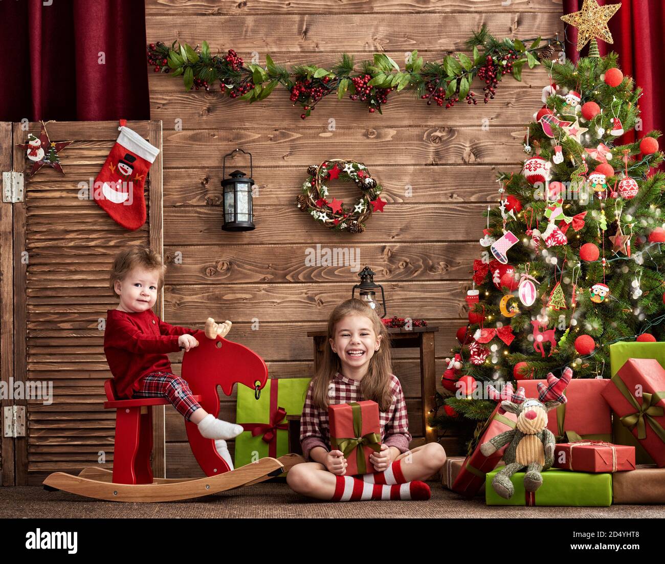 Merry Christmas and Happy Holiday! Two cute children sisters girls ...