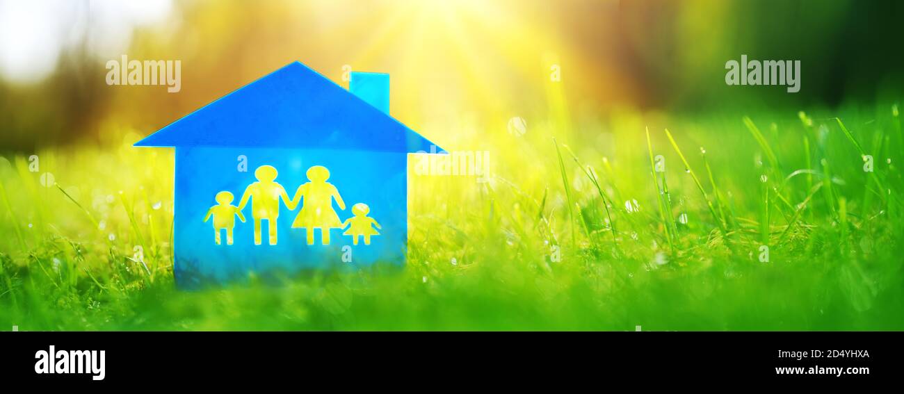Blue family house is on green grass on a sunny day. Model of a housing ...