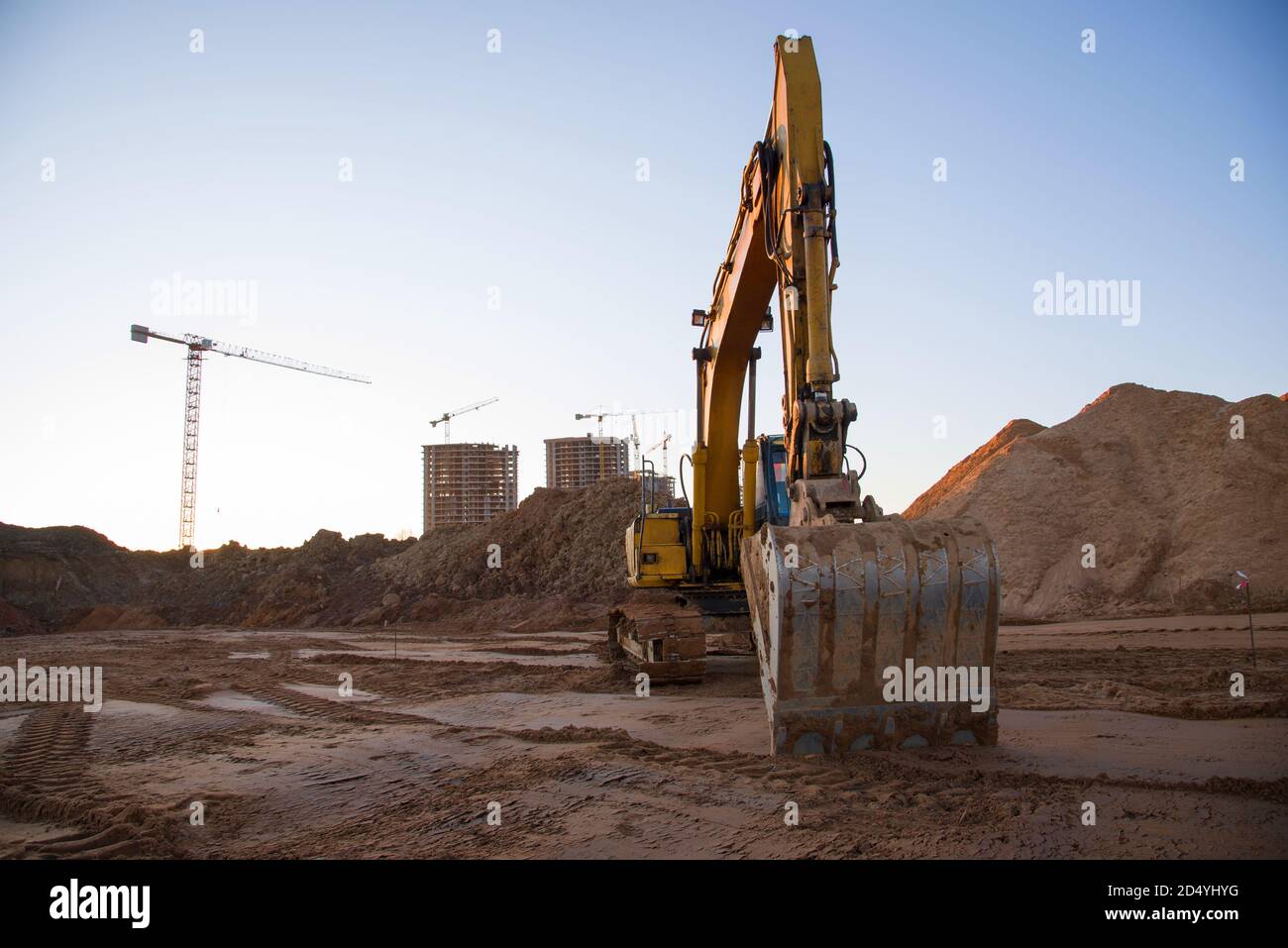Excavator working at construction site. Backhoe digs ground for the ...