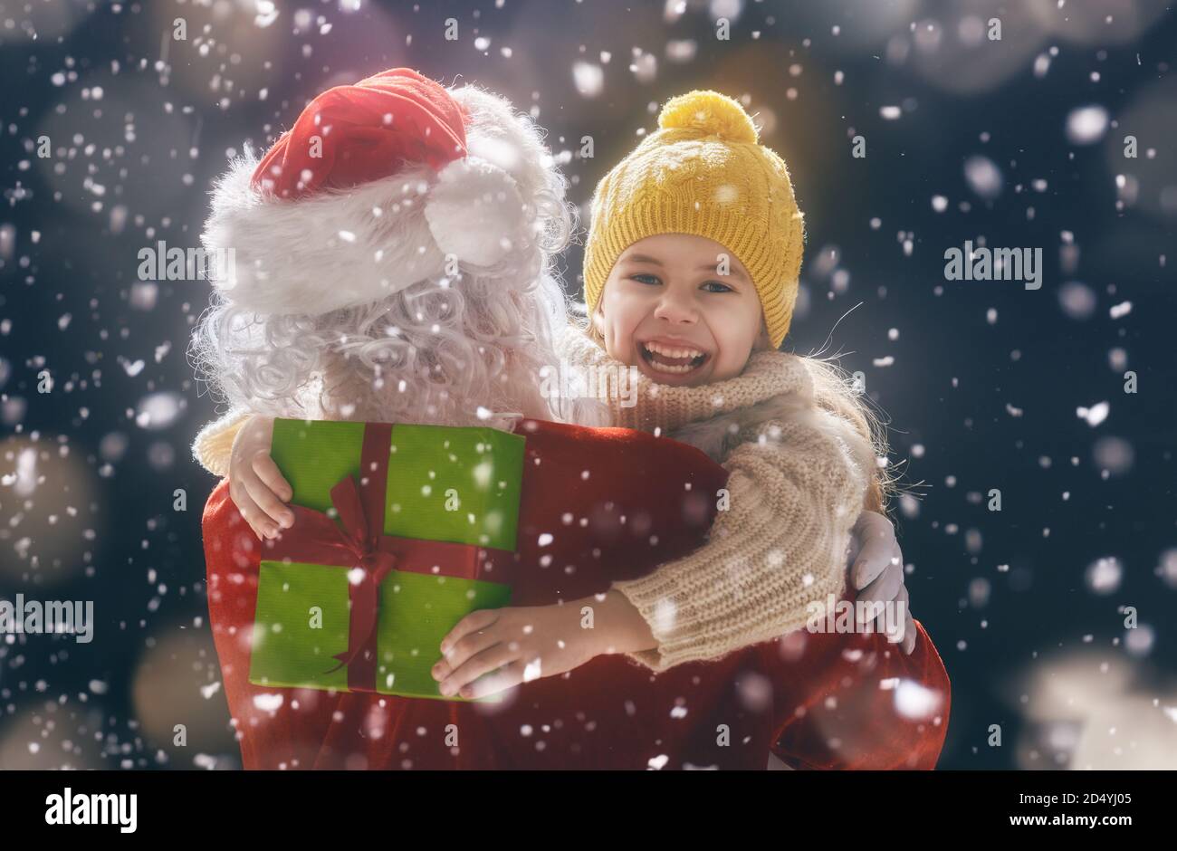 Merry Christmas and happy holidays! Cute little child girl hugging ...
