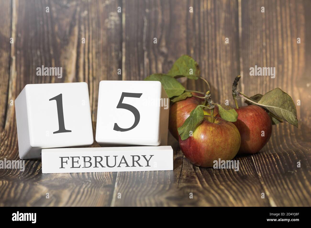 February 15. Day 15 of month. Calendar cube on wooden background with ...
