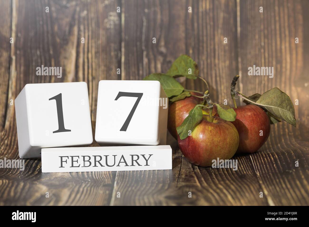February 17. Day 17 of month. Calendar cube on wooden background with ...