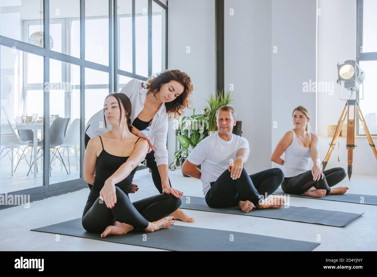 Yoga class of young people group indoor Stock Photo - Alamy