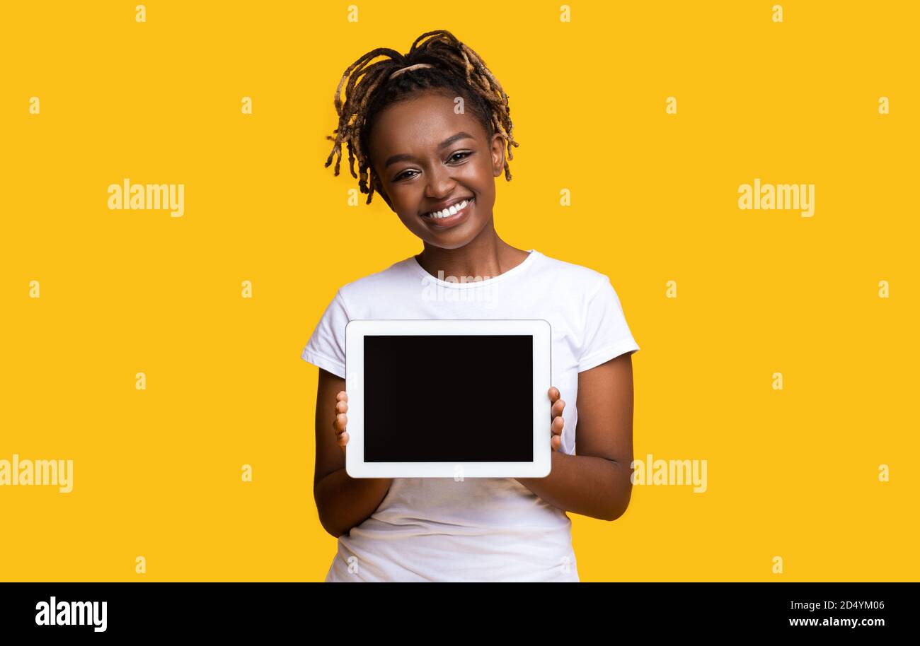 Happy black woman holding digital tablet with blank screen Stock Photo ...